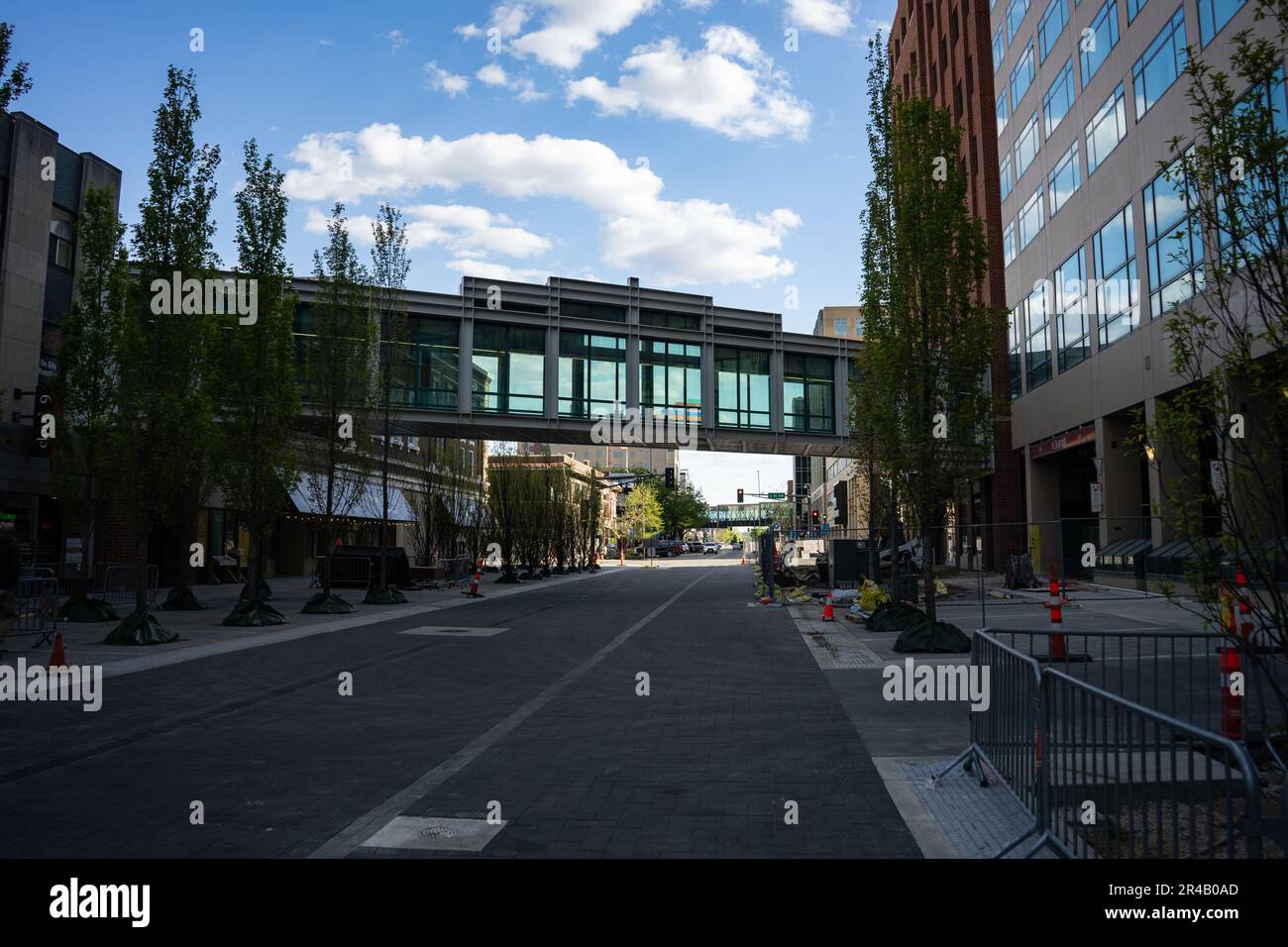 A bustling city street with a bridge structure arching over it ...