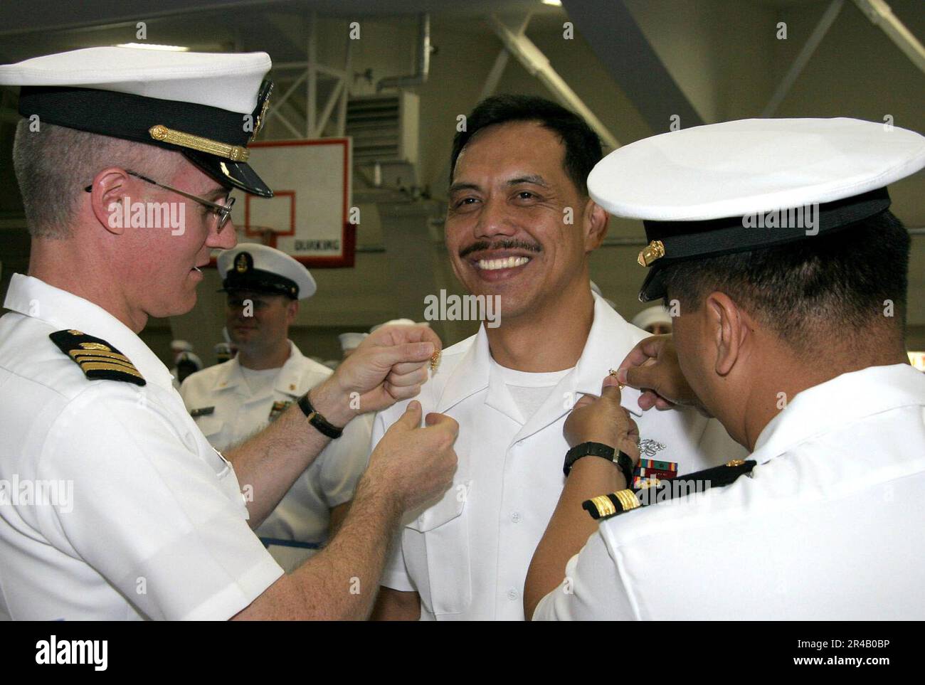 US Navy Senior Chief Petty Officer smile as his senior chief anchors ...