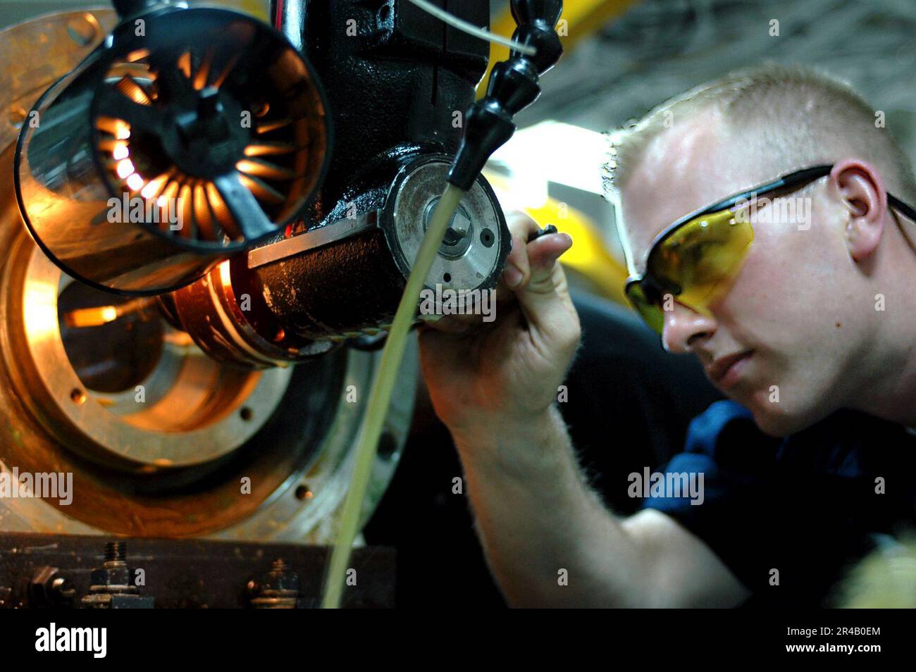 US Navy Machinery Repairmen 3rd Class performs repairs on the ships ...