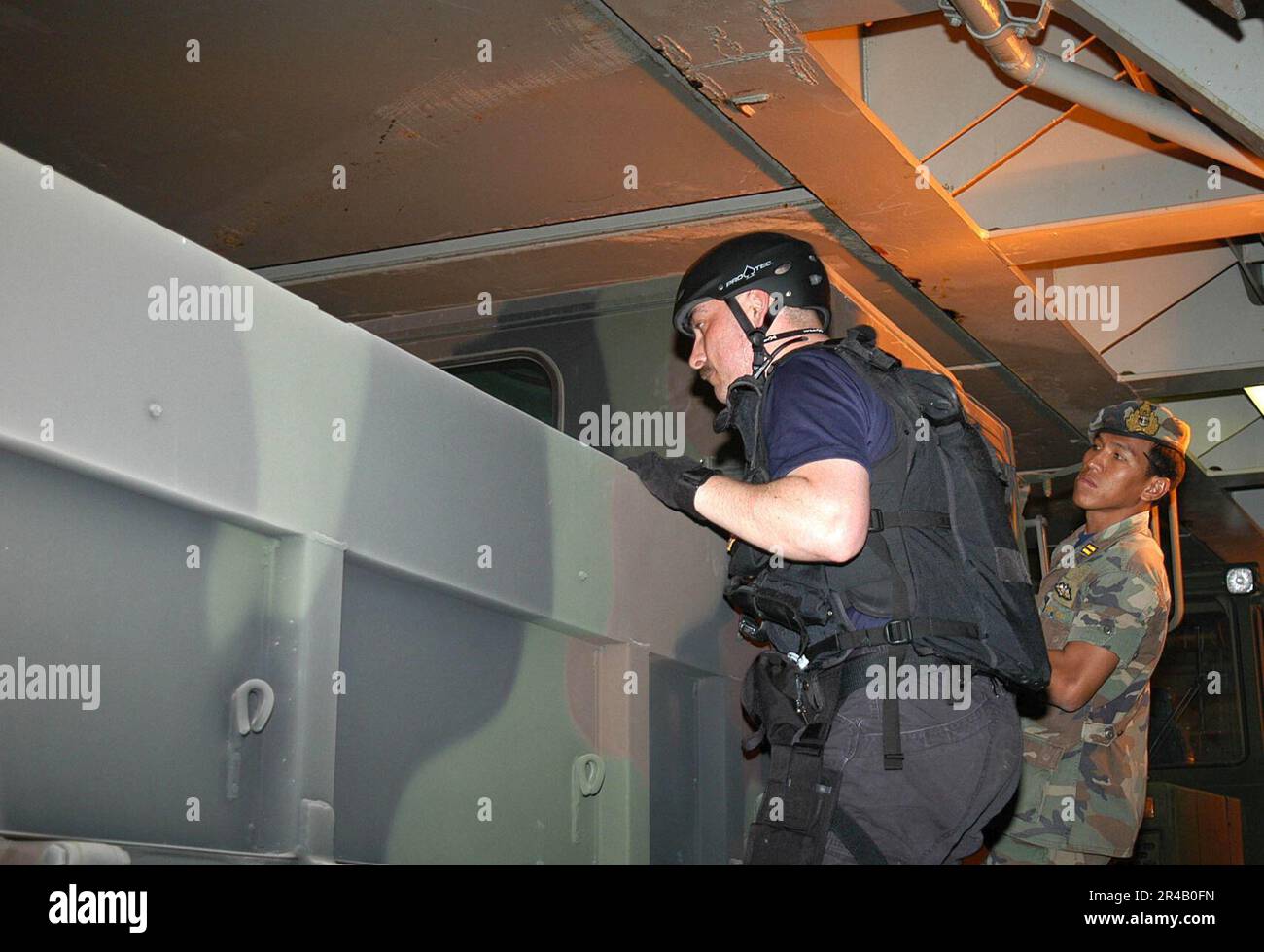 US Navy A Royal Thai Navy liaison officer observes a Sailor assigned to ...