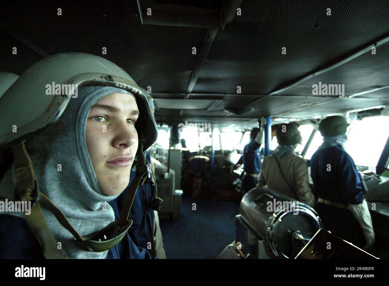 US Navy Seaman Apprentice stands helmsman watch during a general ...