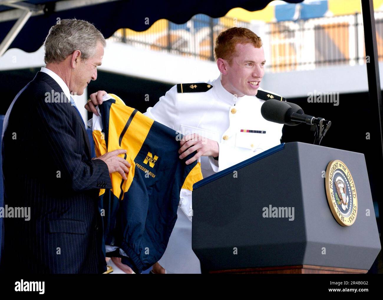 US Navy A graduating Midshipman presents U.S. President George W. Bush ...