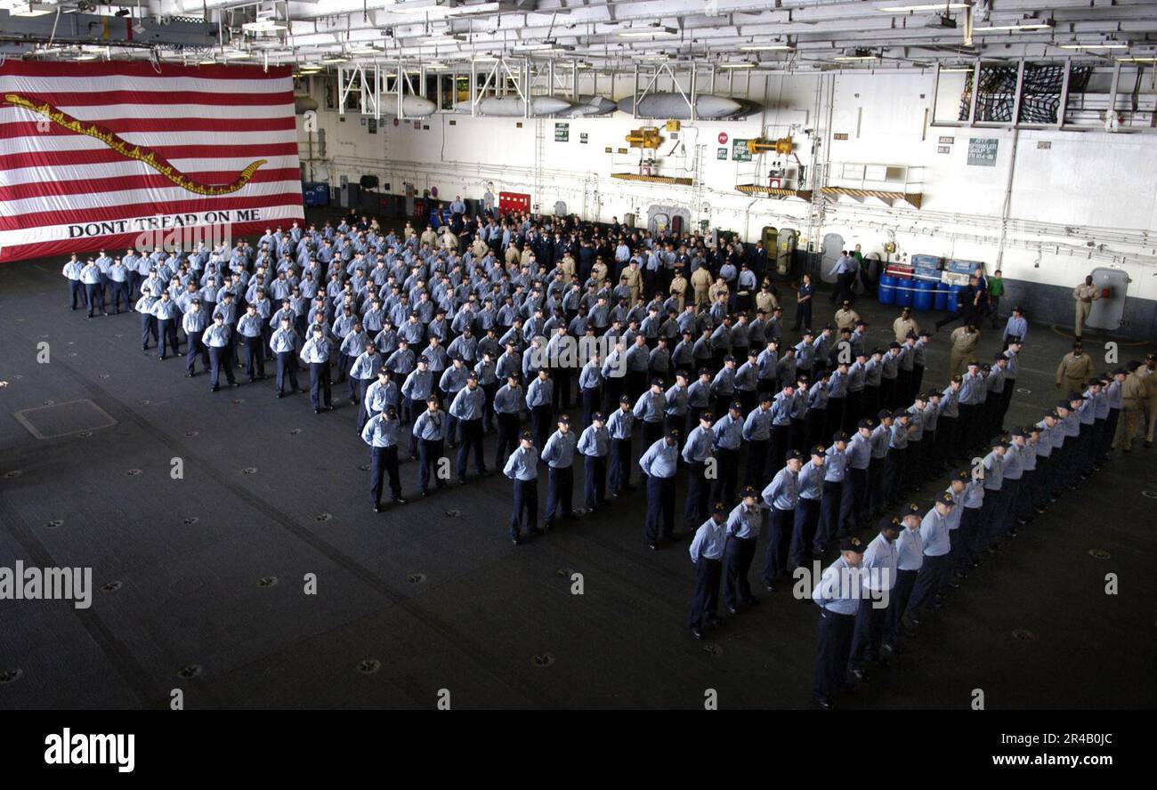 US Navy Sailors stand in formation awaiting the arrival of USS Kitty ...