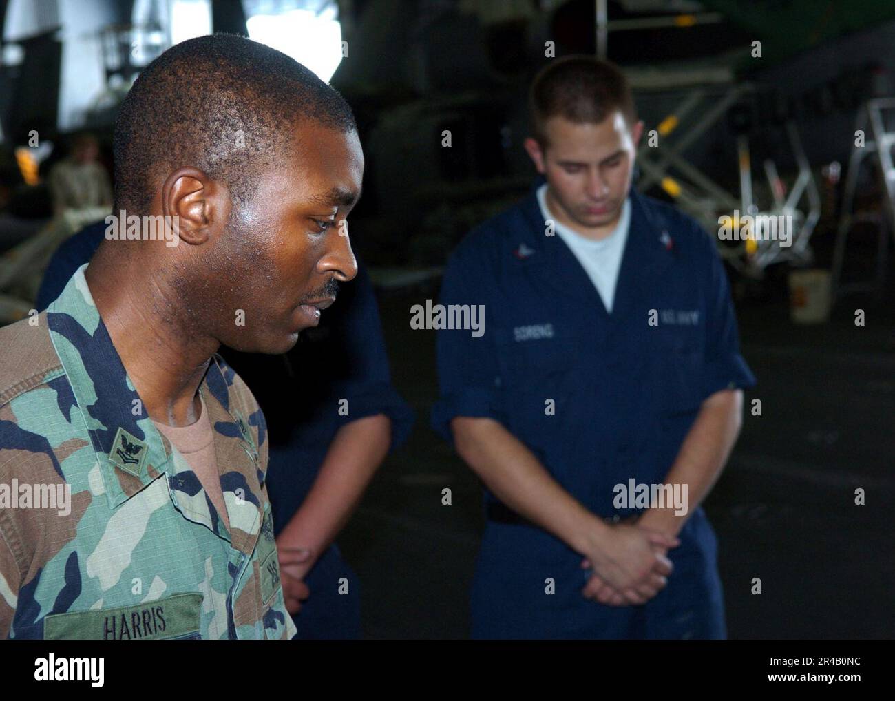 US Navy Sailors stand fast during a moment of silence to honor all ...
