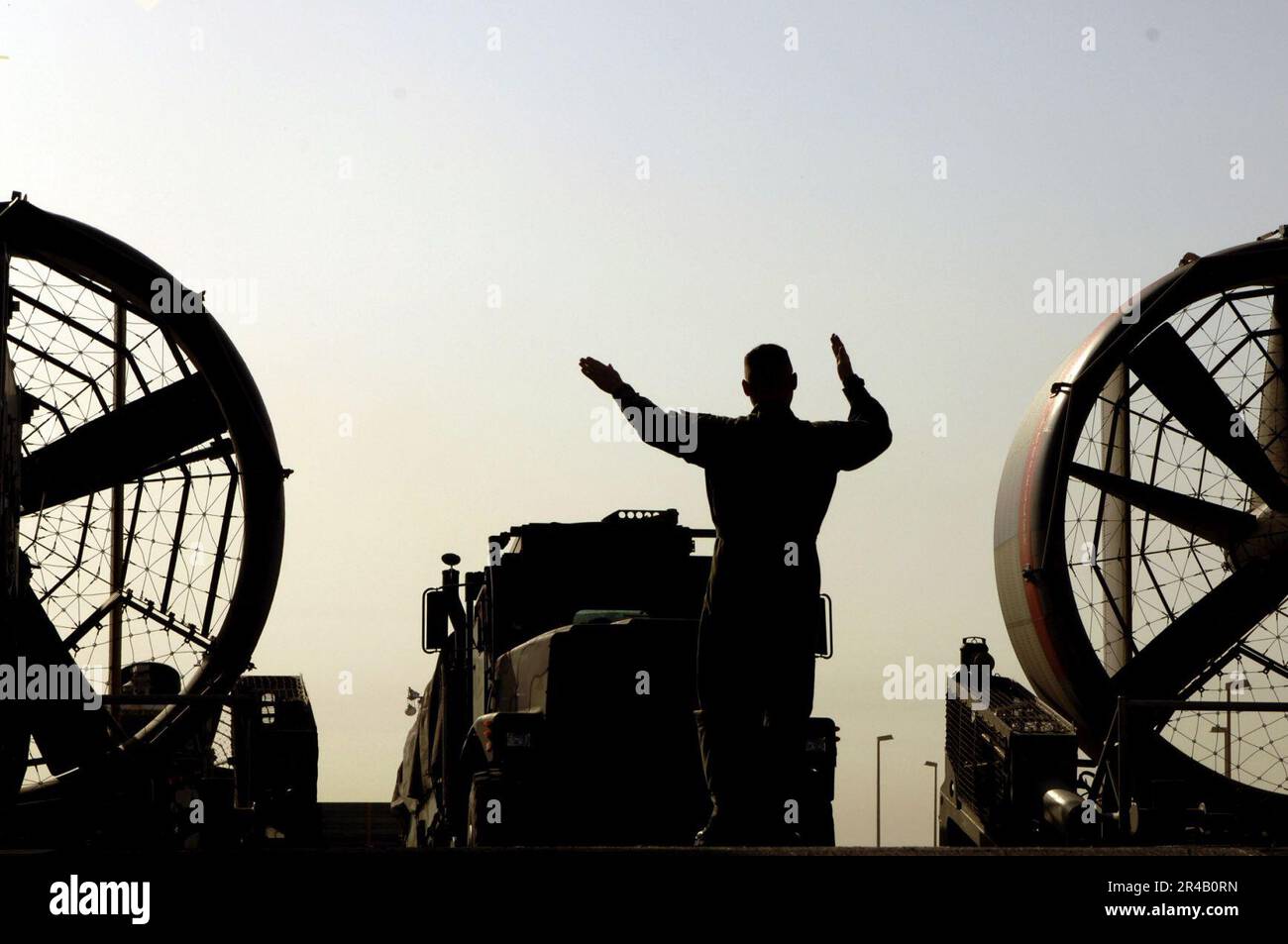 US Navy Beachmaster, Boatswain's Mate 1st Class helps on-load heavy ...