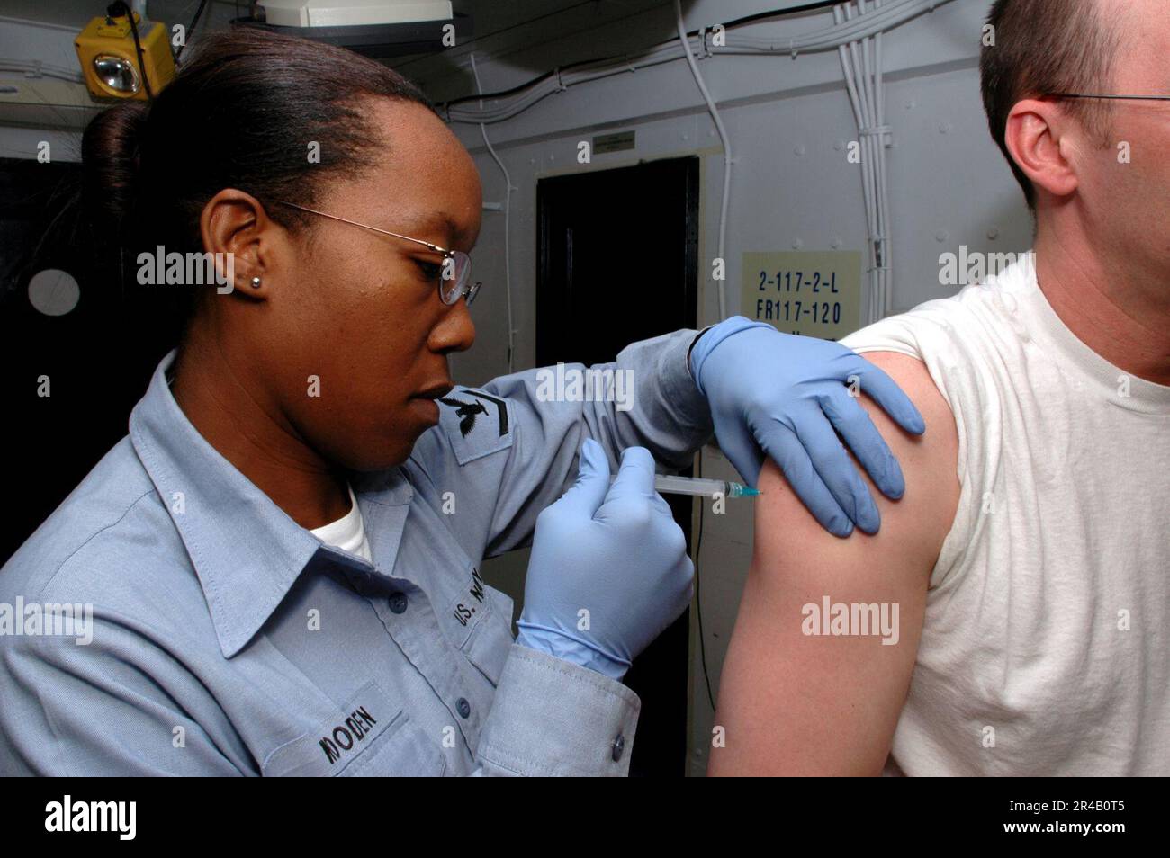 US Navy Hospital Corpsman 3rd Class administers a Hepatitis-B vaccine ...