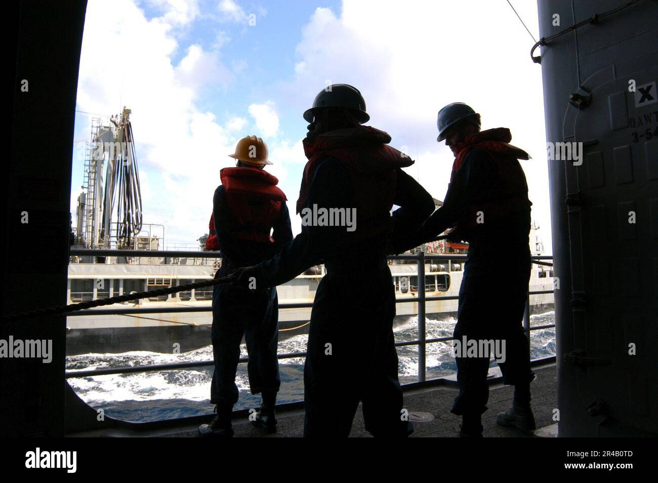 US Navy Sailors stationed aboard the amphibious command ship USS Blue ...