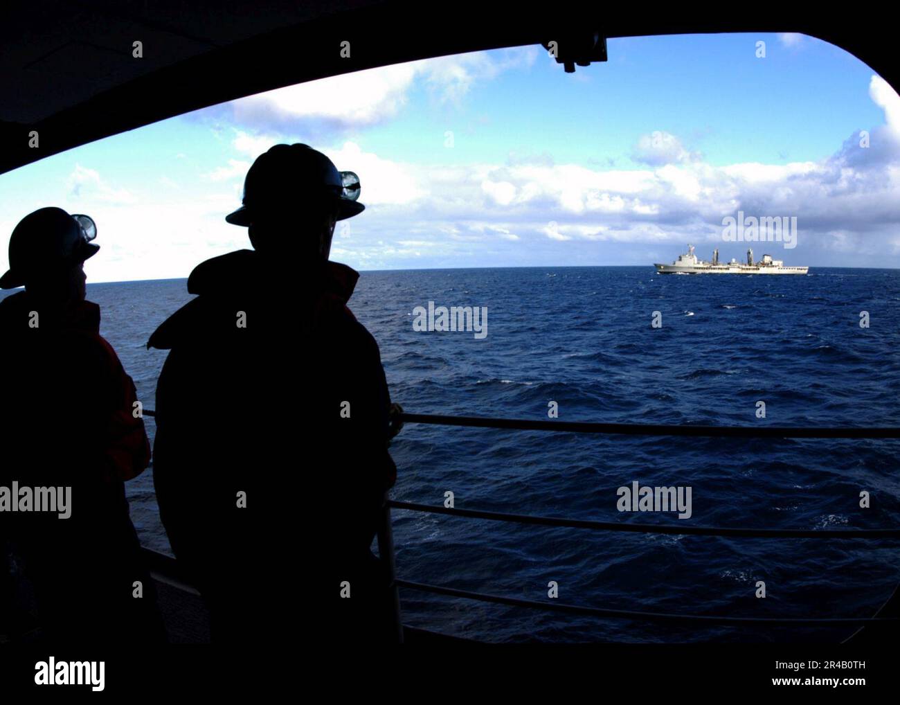 US Navy Two Sailors assigned to an underway replenishment detail aboard ...
