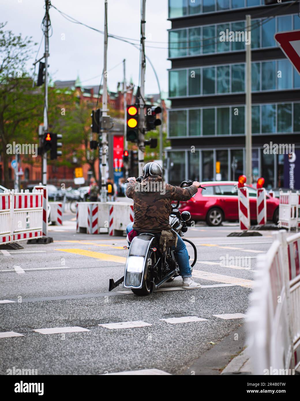 A man on a motorcycle navigating through a busy city street with ...