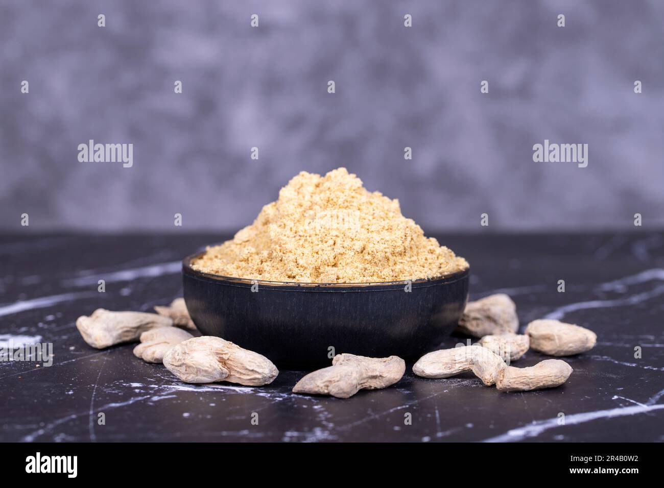 Ginger powder on dark background. Powdered dried ginger in bowl Stock ...