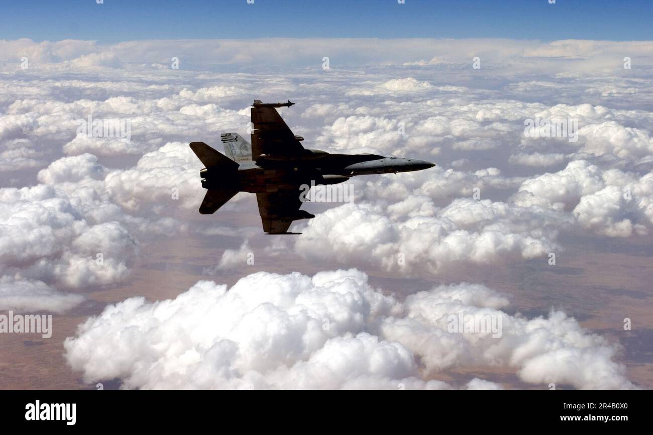 US Navy An F-A-18C Hornet rolls into a turn while performing operations ...