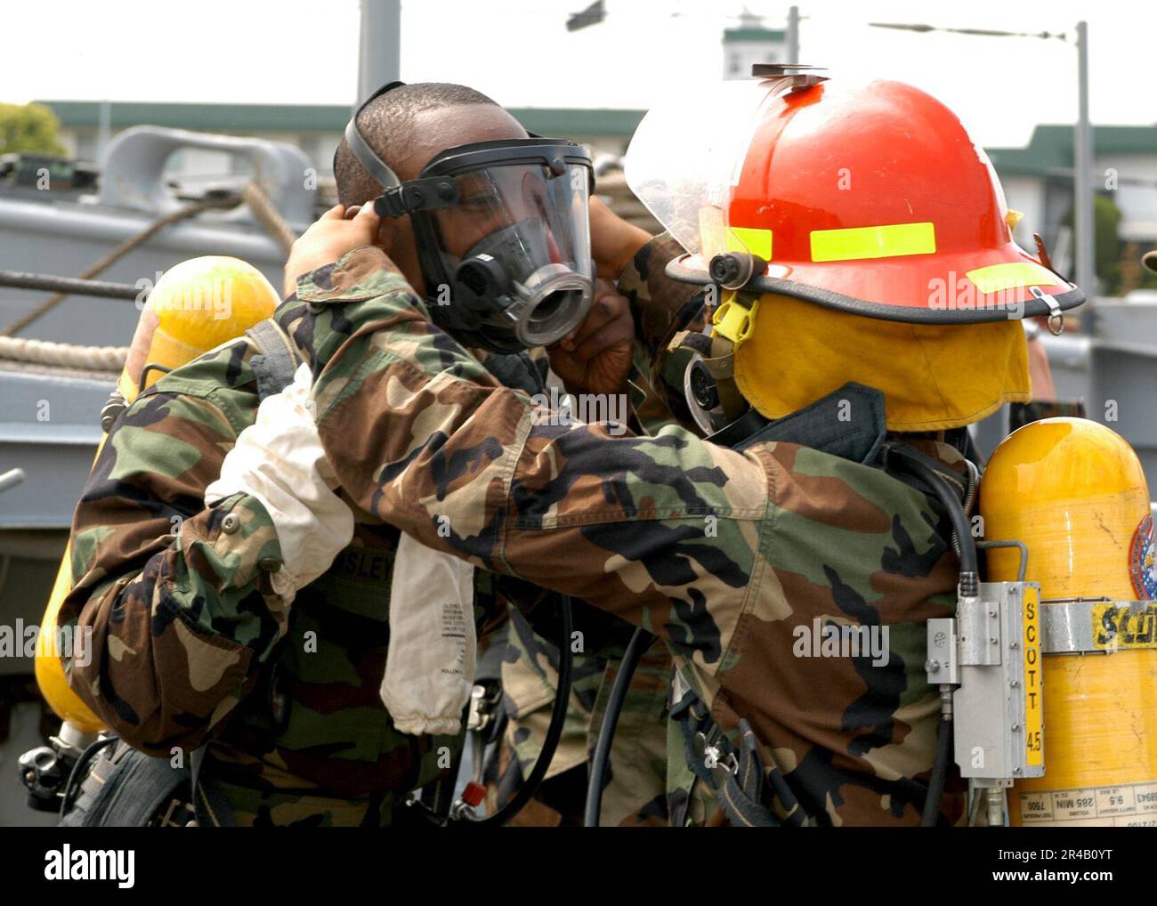 US Navy Electrician's Mate 3rd Class left, is assisted by Seaman ...