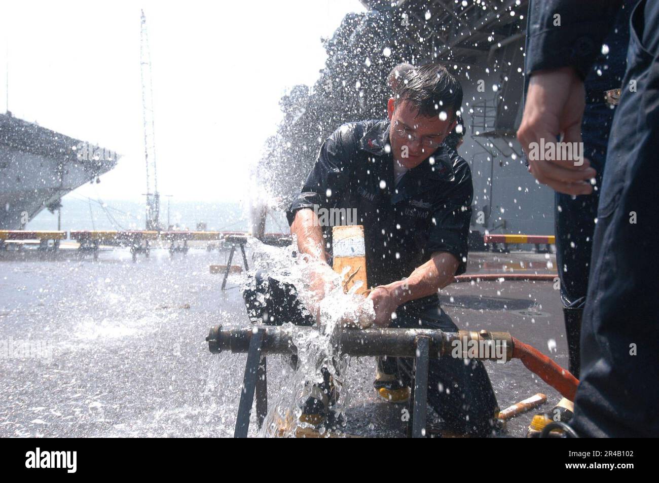 US Navy Yeoman 2nd Class fits a wedge into a ruptured pipe Stock Photo ...