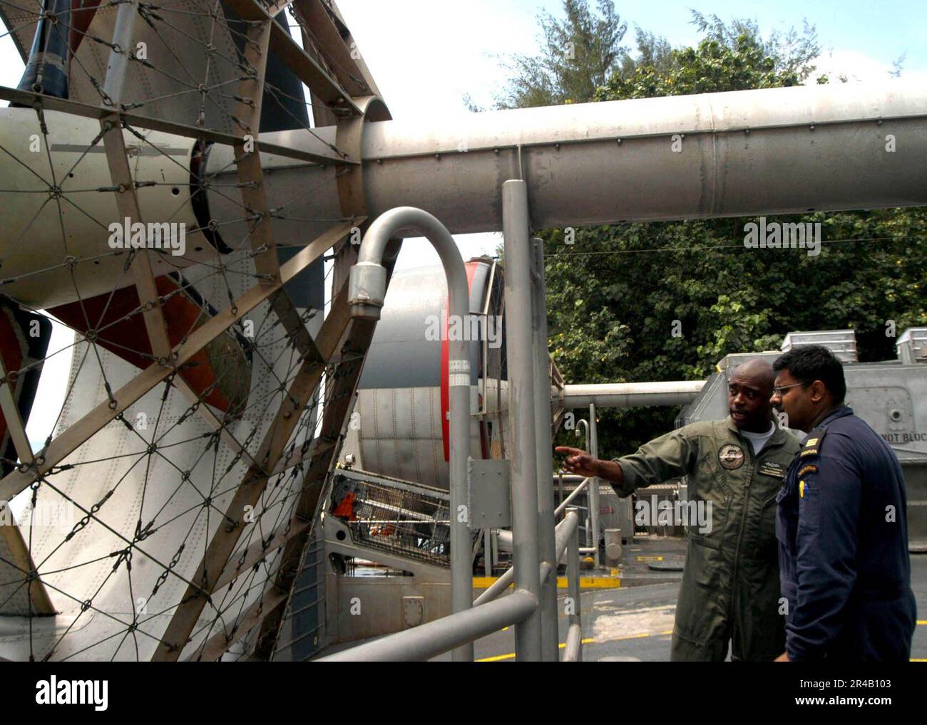 US Navy Chief Gas Turbine System Technician Mechanical left, explains ...