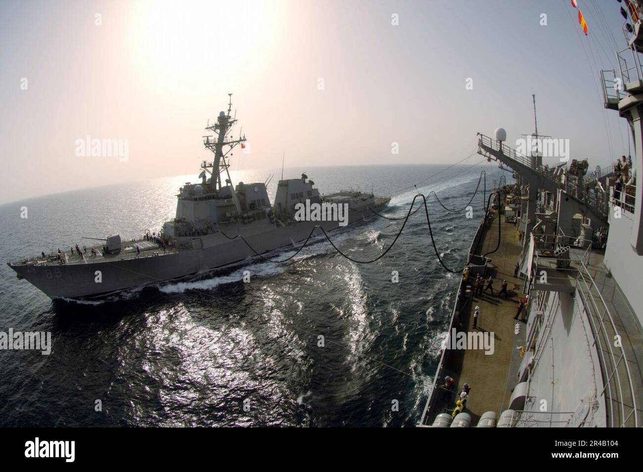 US Navy USS Mustin (DDG 89) cruises alongside the fast combat support ...