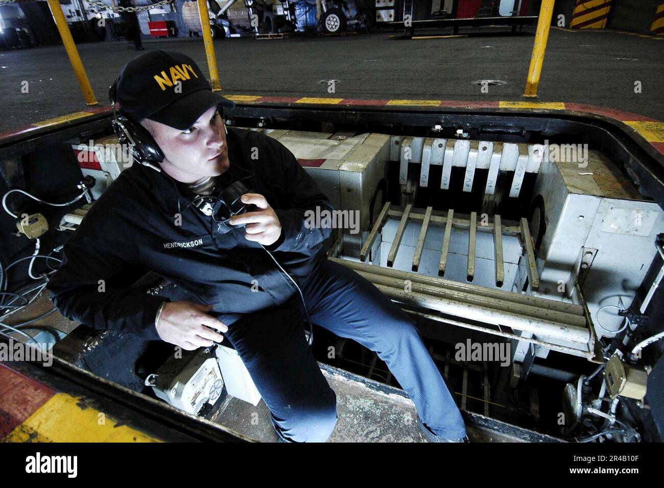 US Navy Aviation Boatswain's Mate Handler phone talker, stands-by in an ...