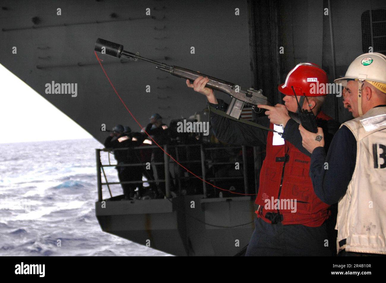 US Navy Aviation Ordnanceman Airman prepares to shoot M-14 rifle with a ...
