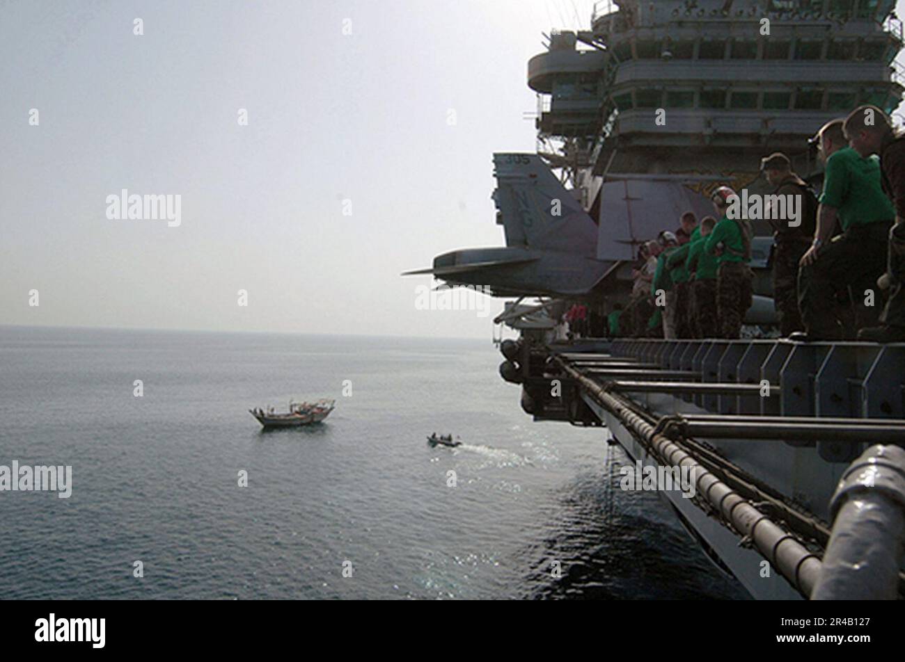 US Navy Flight deck personnel observe a Rigid Inflatable Hull Boat ...