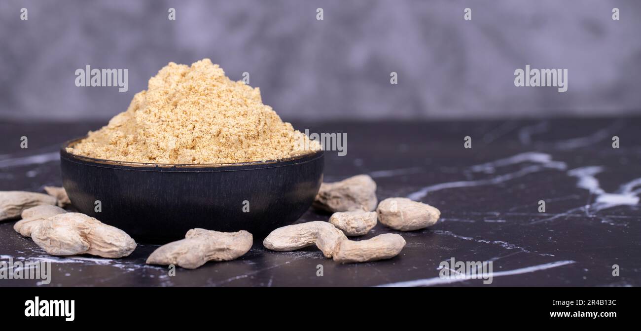 Ginger powder on dark background. Powdered dried ginger in bowl Stock ...
