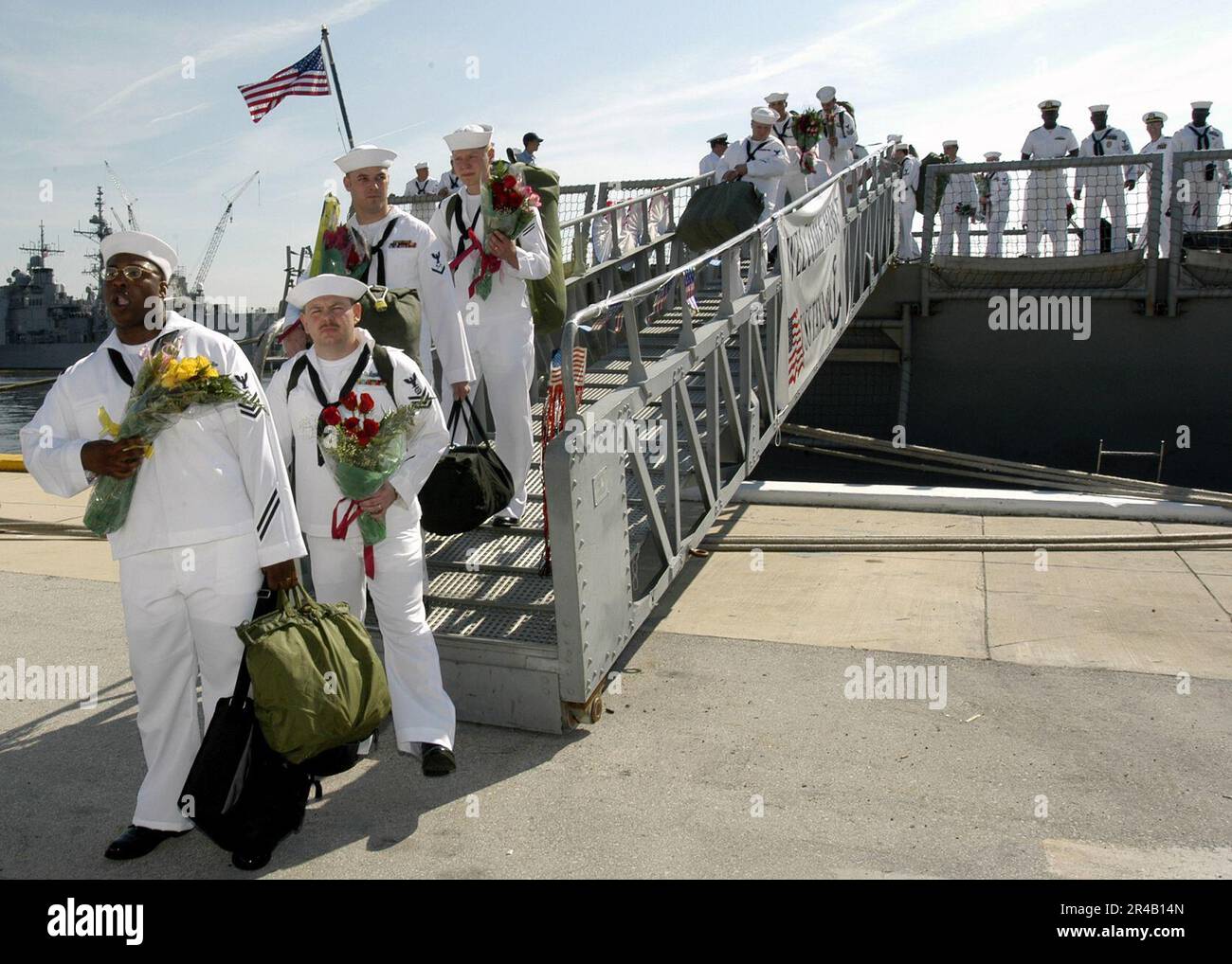US Navy Sailors anxiously disembark the guided missile frigate USS ...
