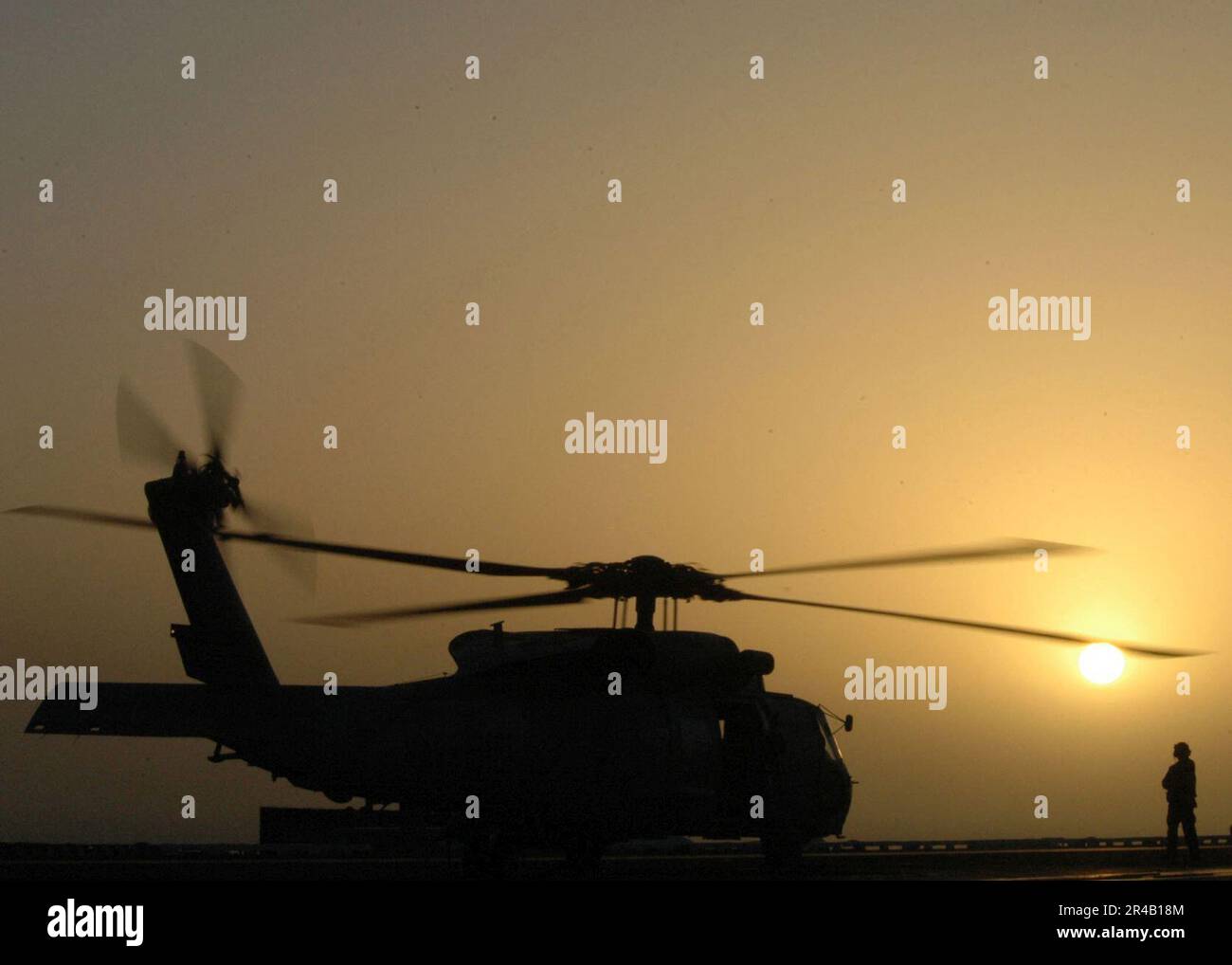 US Navy A landing signalman enlisted (LSE) guides the pilots of an SH ...