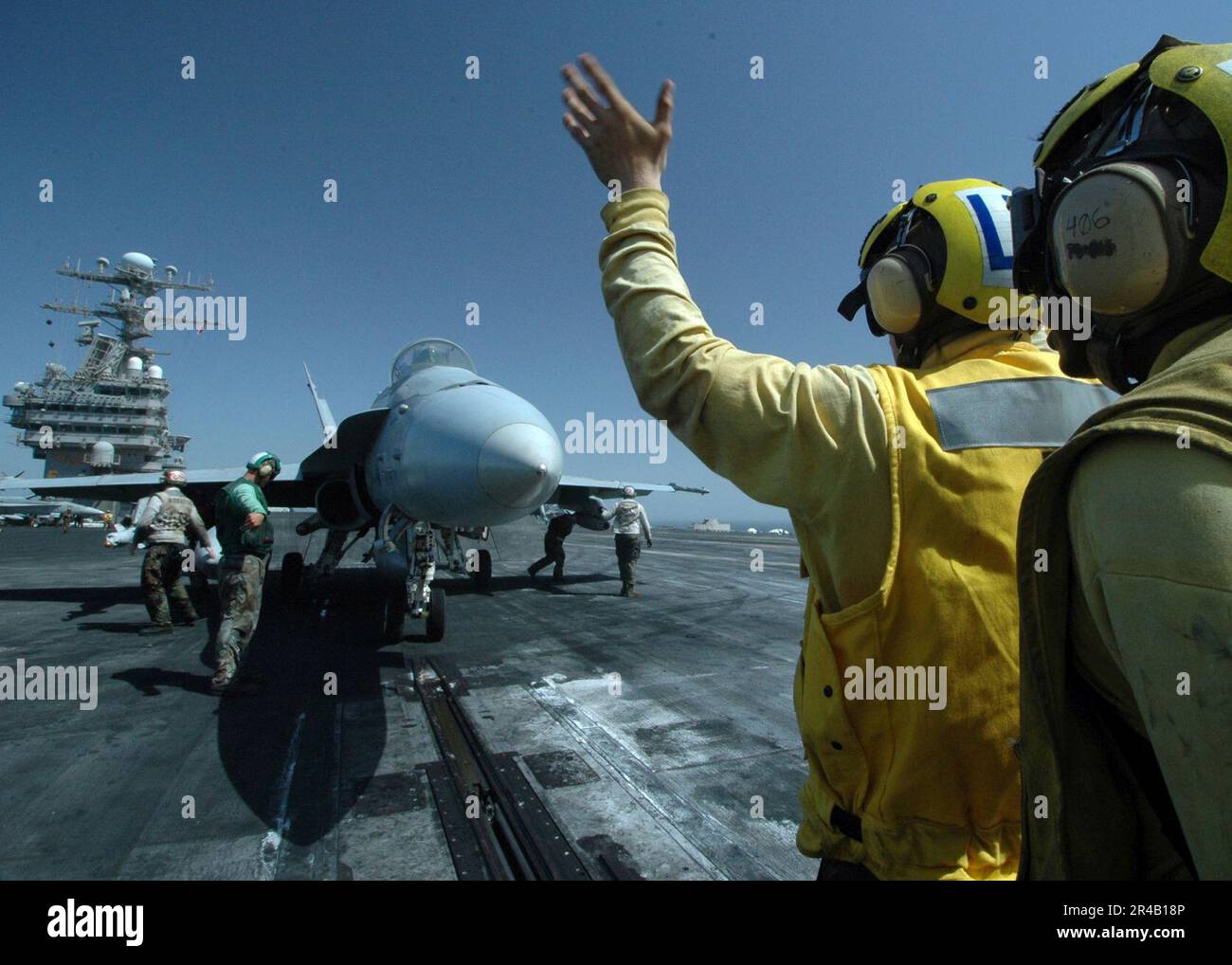 US Navy Aviation Boatswain's Mate 3rd Class keeps a close eye over ...