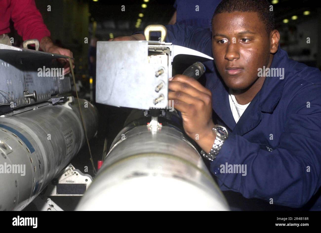 US Navy Airman performs a final inspection on an AGM-88 High-Speed Anti ...