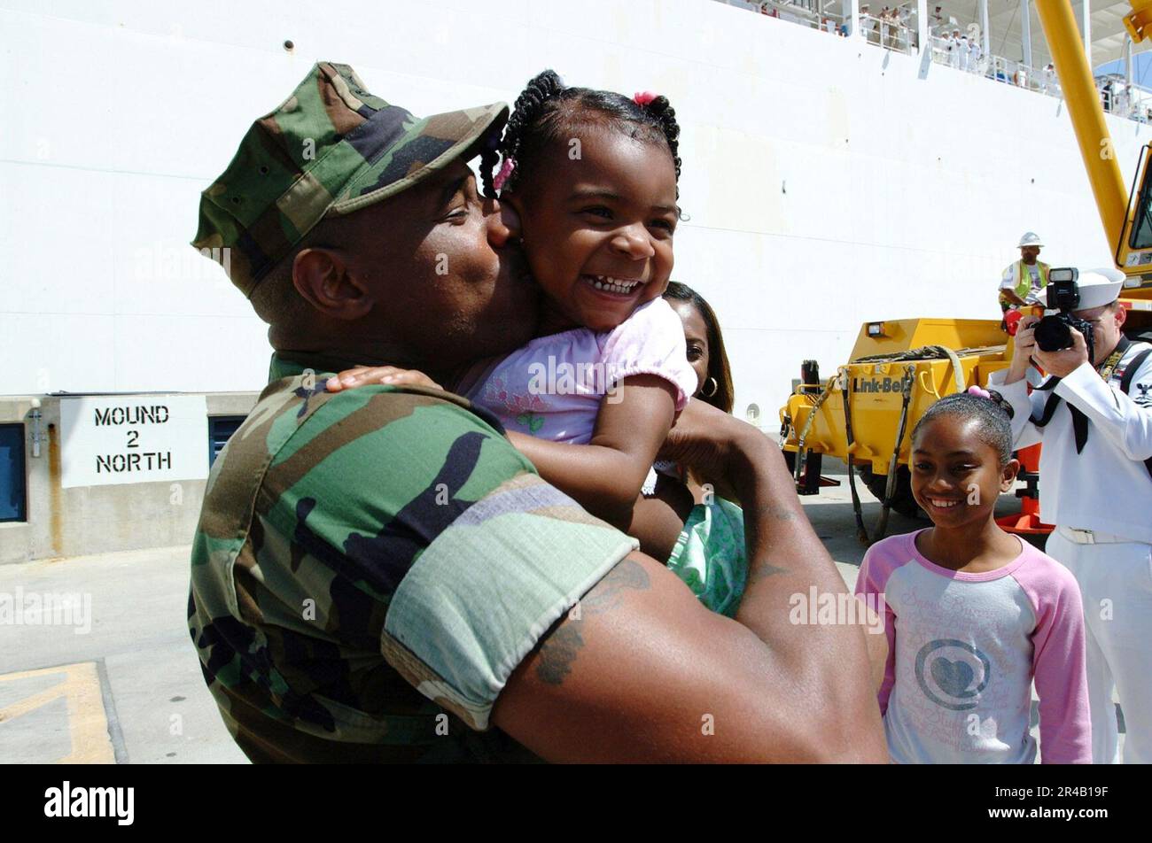 US Navy Storekeeper 2nd Class kisses his daughter after getting off the ...