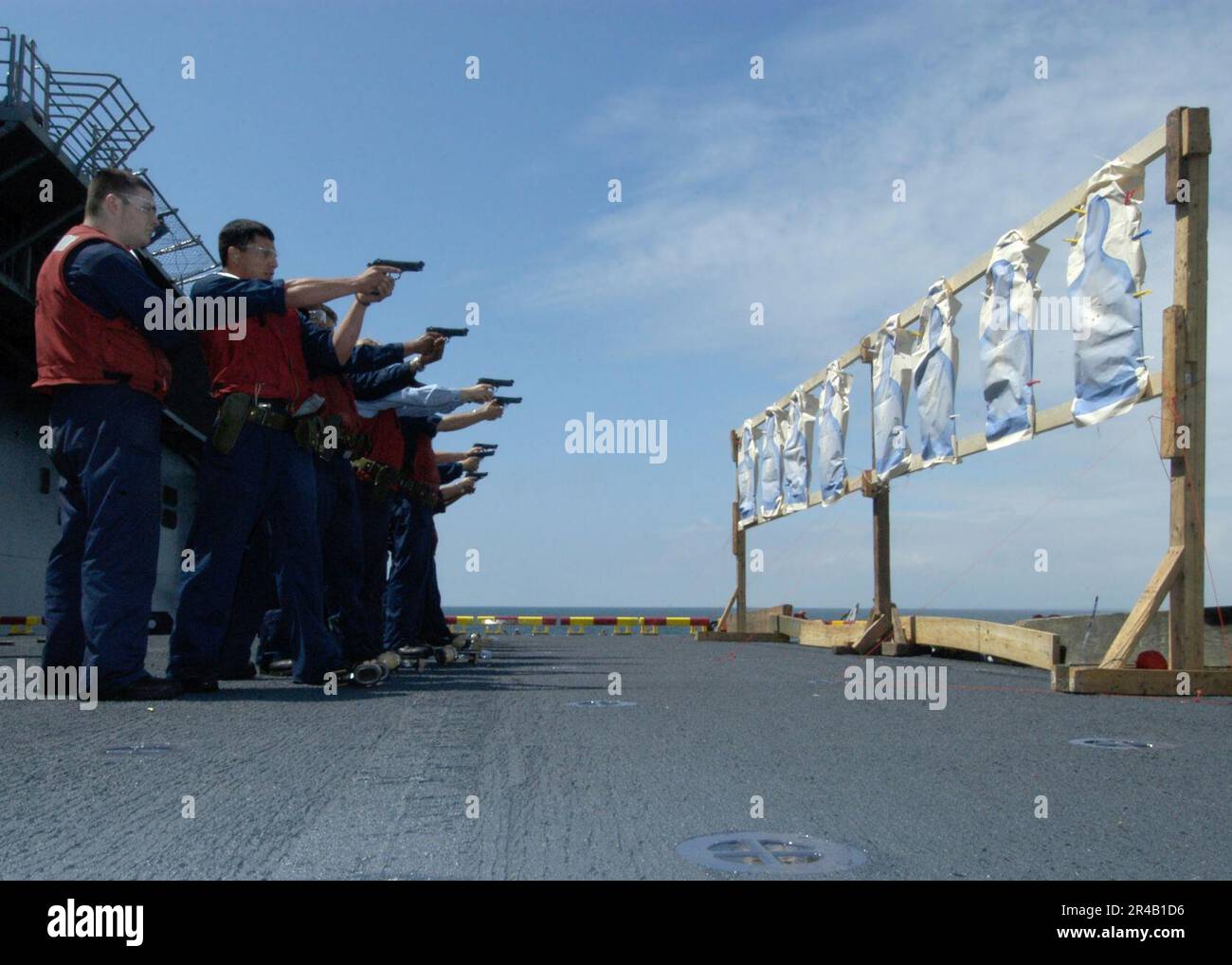 US Navy Personnel take aim at their targets during a live-fire 9mm ...