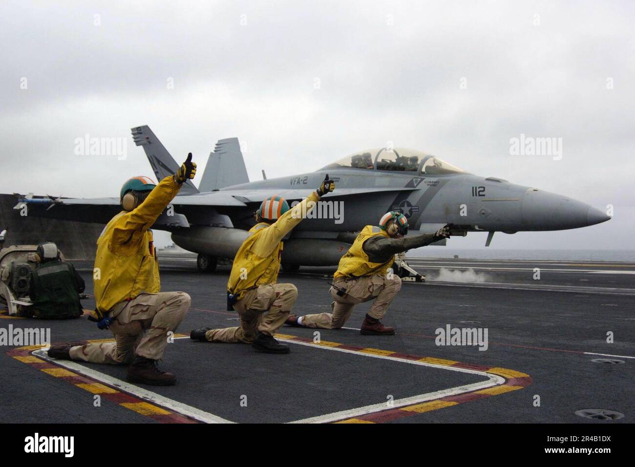 US Navy Three Catapult Officers simultaneously launch an F-A-18F Super ...