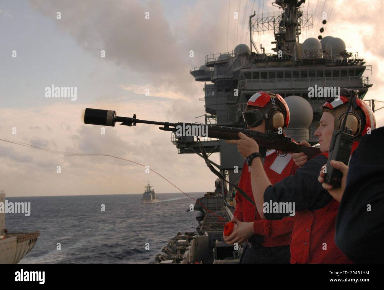 US Navy Midshipman 4th Class fires an M-14 rifle, attached with an MK ...