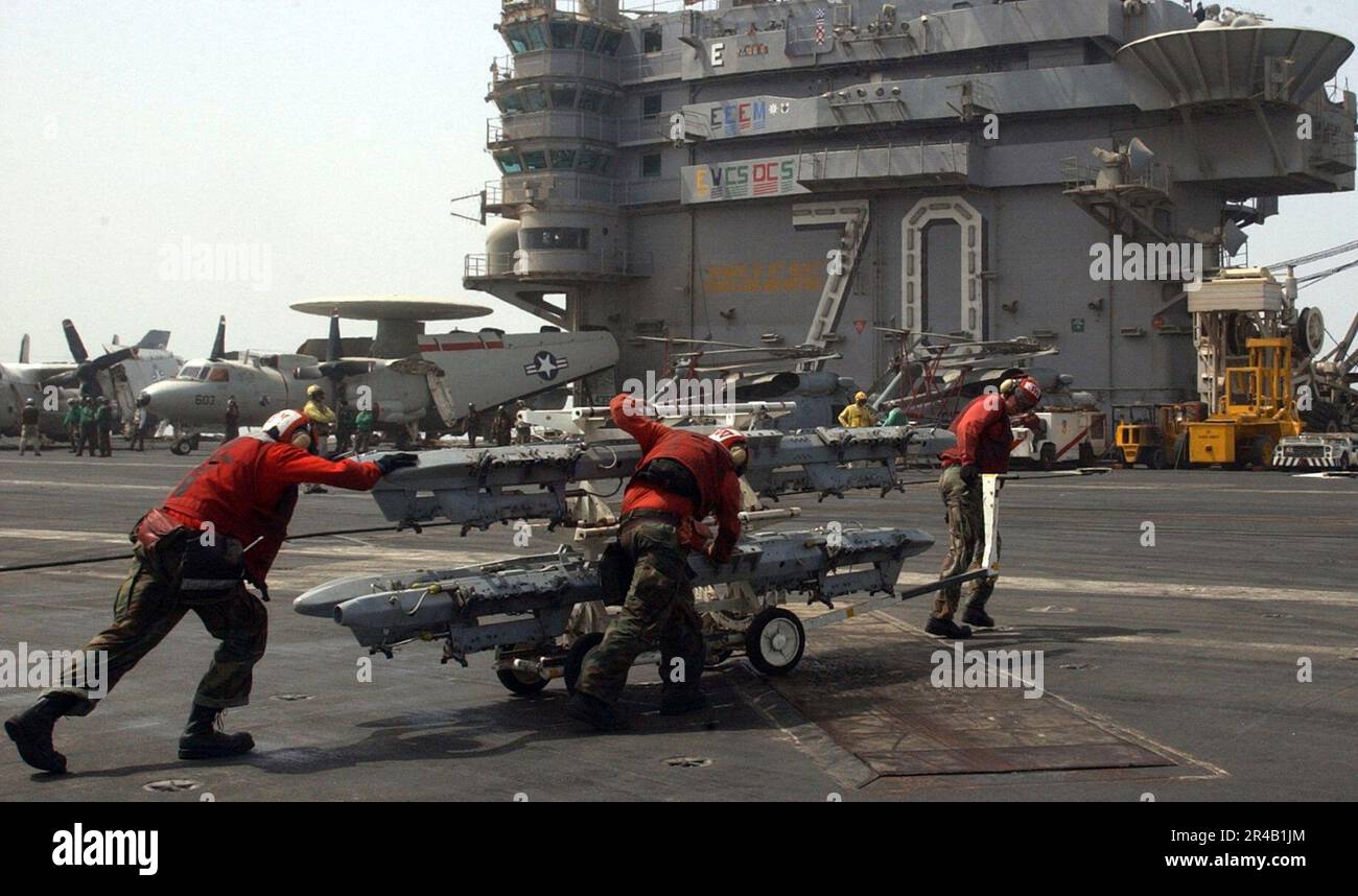 US Navy Aviation Ordnancemen transport ordnance ejector rails across ...