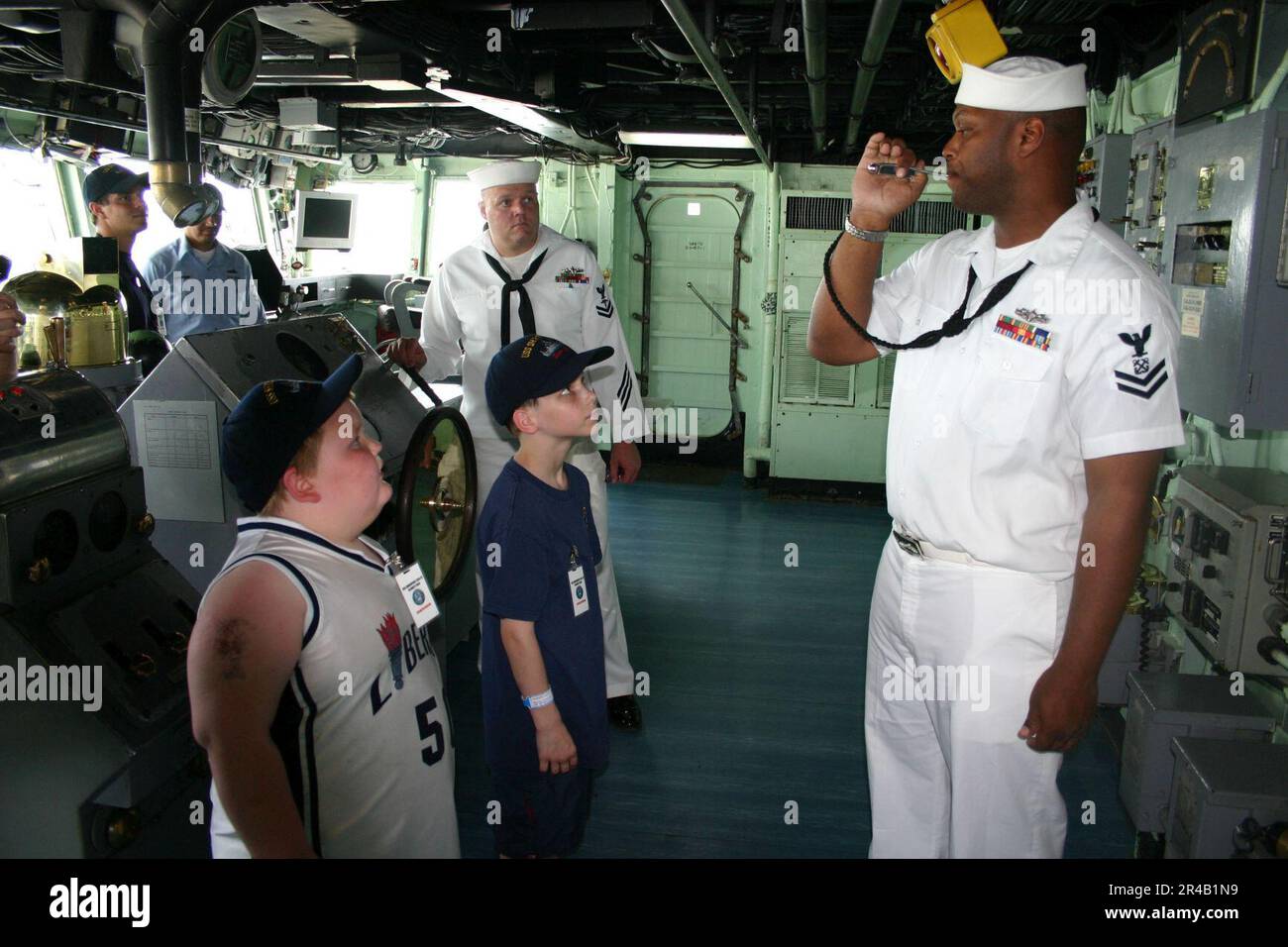 US Navy Boatswain's Mate 1st Class demonstrates the bos'n whistle to ...