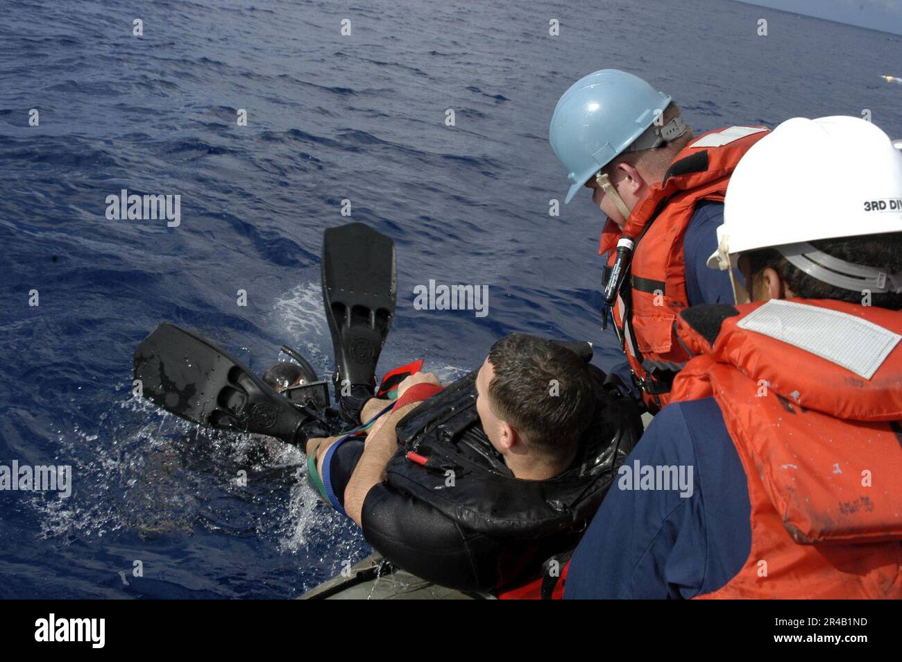 US Navy Rigid Hull Inflatable Boat crew members assist search and ...