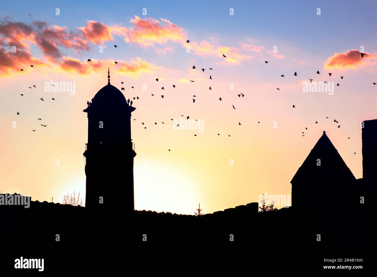 A clock tower with a cupola in the background. Erzurum silhouette ...