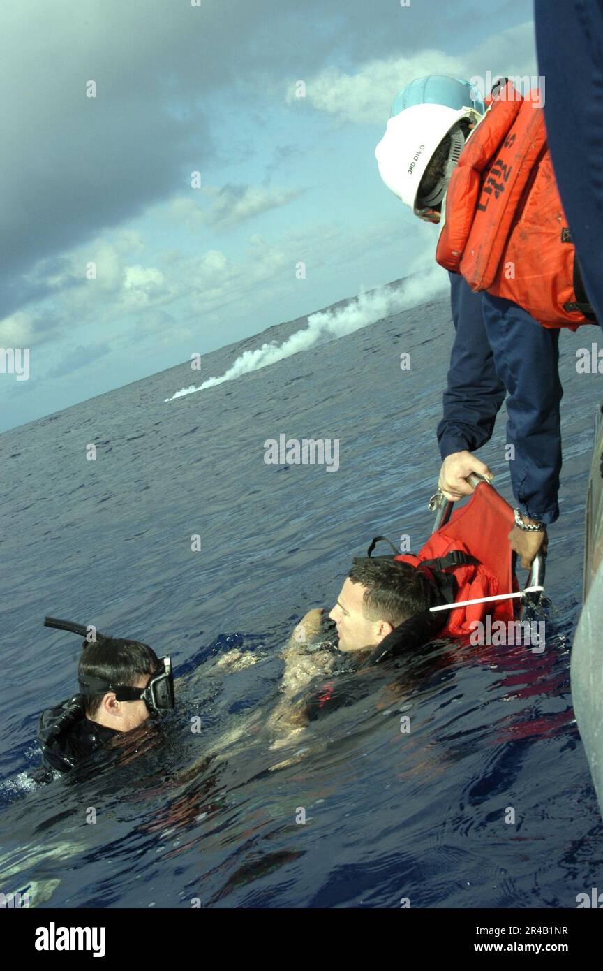 US Navy Rigid Hull Inflatable Boat crew members assist search and ...