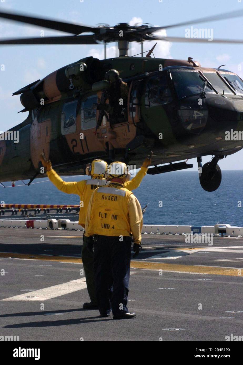 US Navy Air Department personnel use hand signals to communicate to the ...