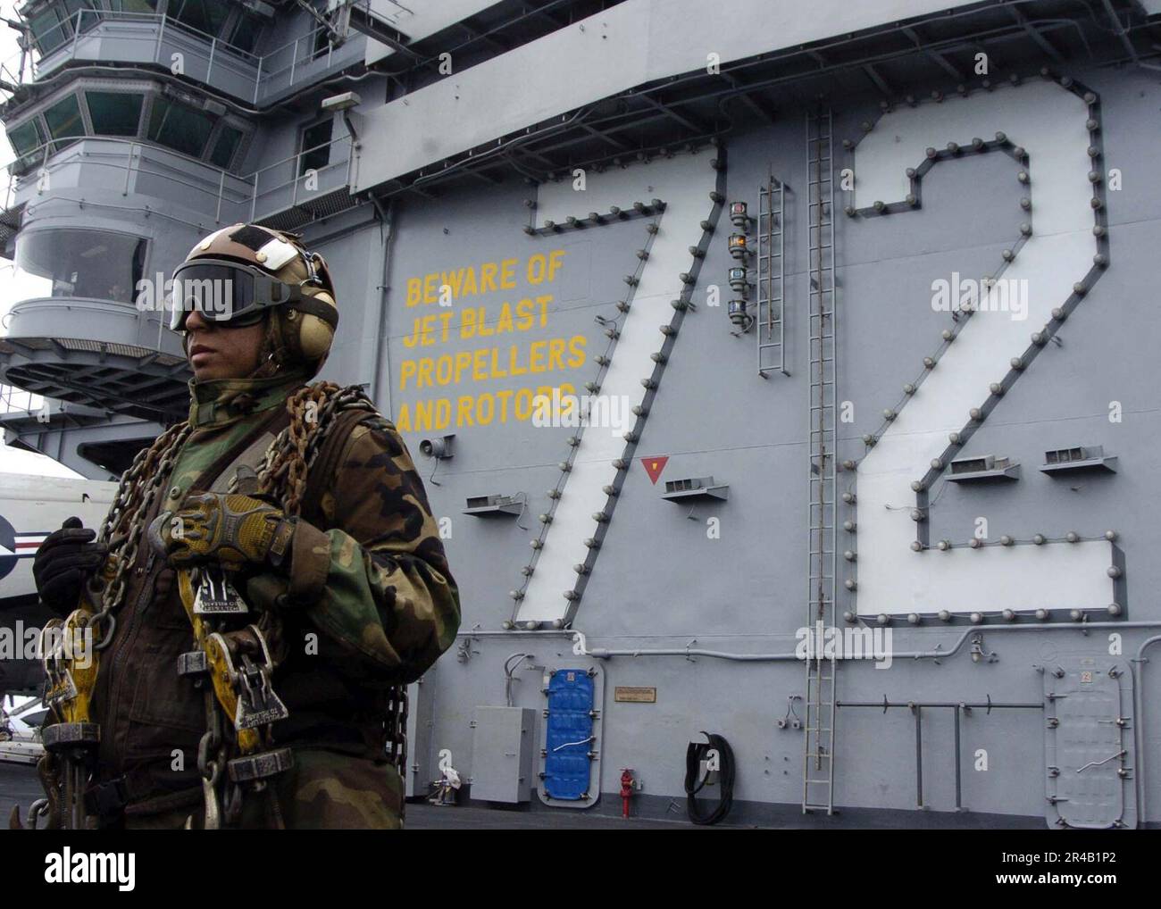 US Navy A Plane Captain stands by on the flight deck aboard the Nimitz ...