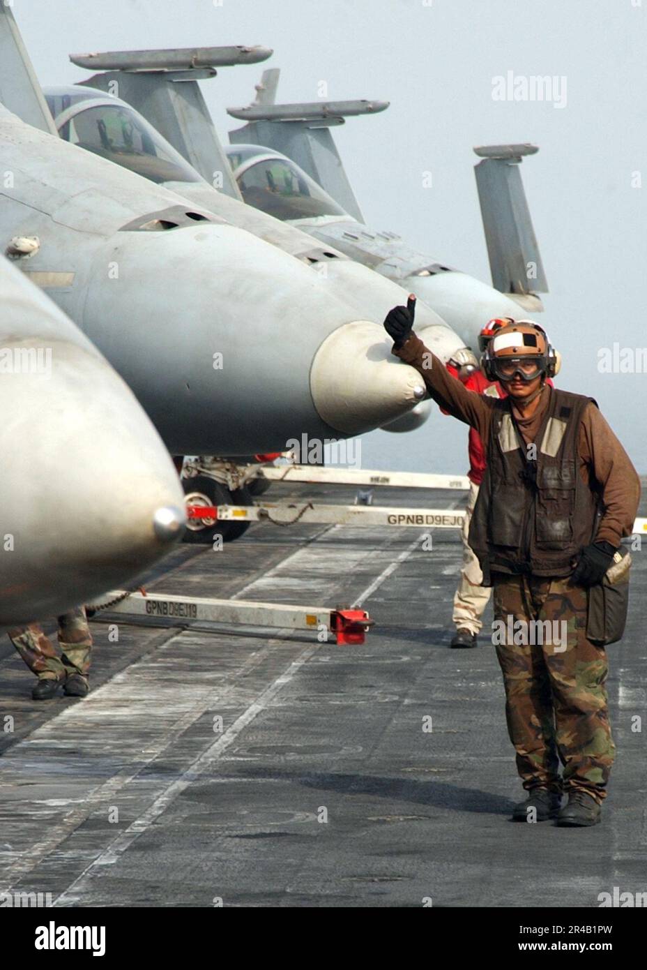 US Navy A Plane Captain gives a thumbs up to the aircraft handling crew ...