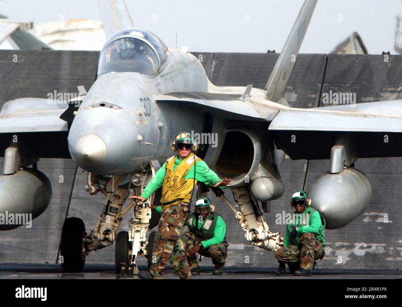 US Navy A catapult safety observer looks to ensure that all personnel ...