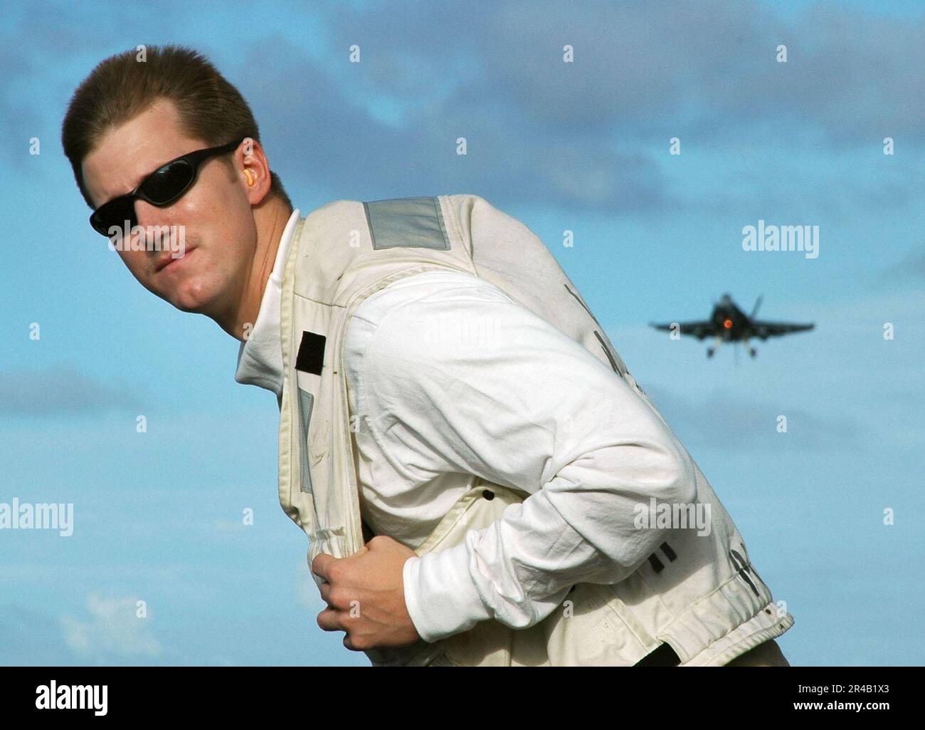 US Navy Lt. waits to signal a clear deck to the Landing Signal Officer ...