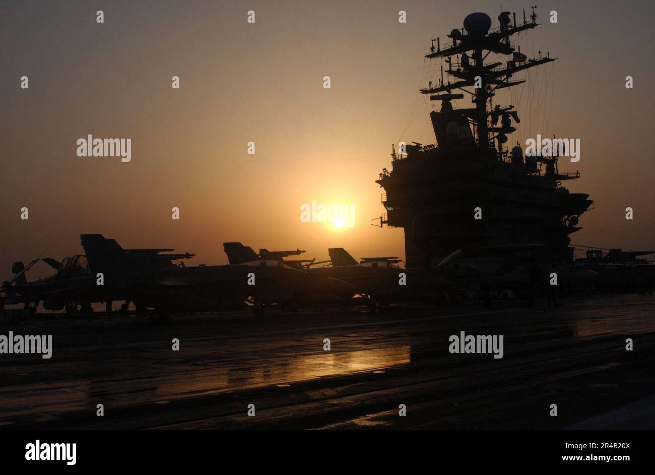 US Navy The sun rises over the flight deck of the Nimitz-class aircraft ...