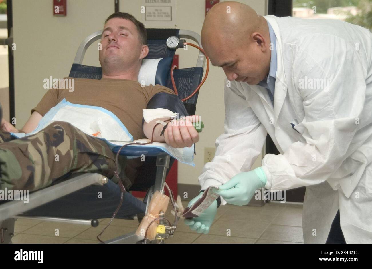 US Navy Hospitalman checks the bag collecting a service member's blood ...
