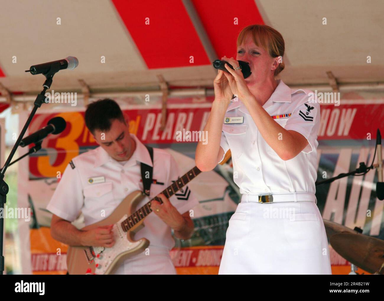 US Navy Musician 2nd Class sings to an audience as Musician 2nd Class ...