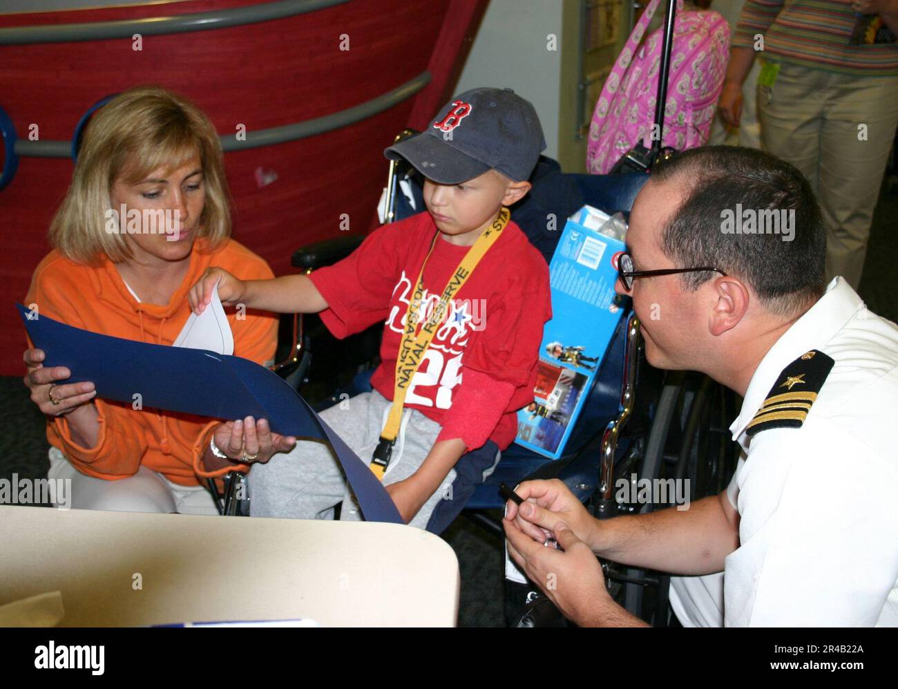 US Navy A young child and his mother look over a Honorary Sailor ...