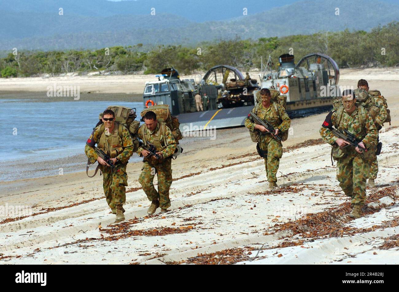 US Navy Australian Army Soldiers move up the beach at Sabina Point ...