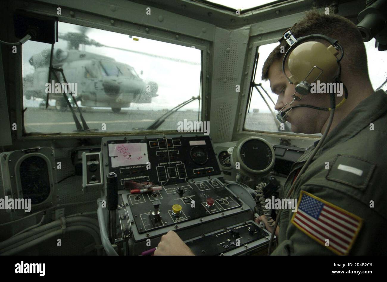 US Navy Lt.j.g assists landing an SH-60B Seahawk aboard the guided ...
