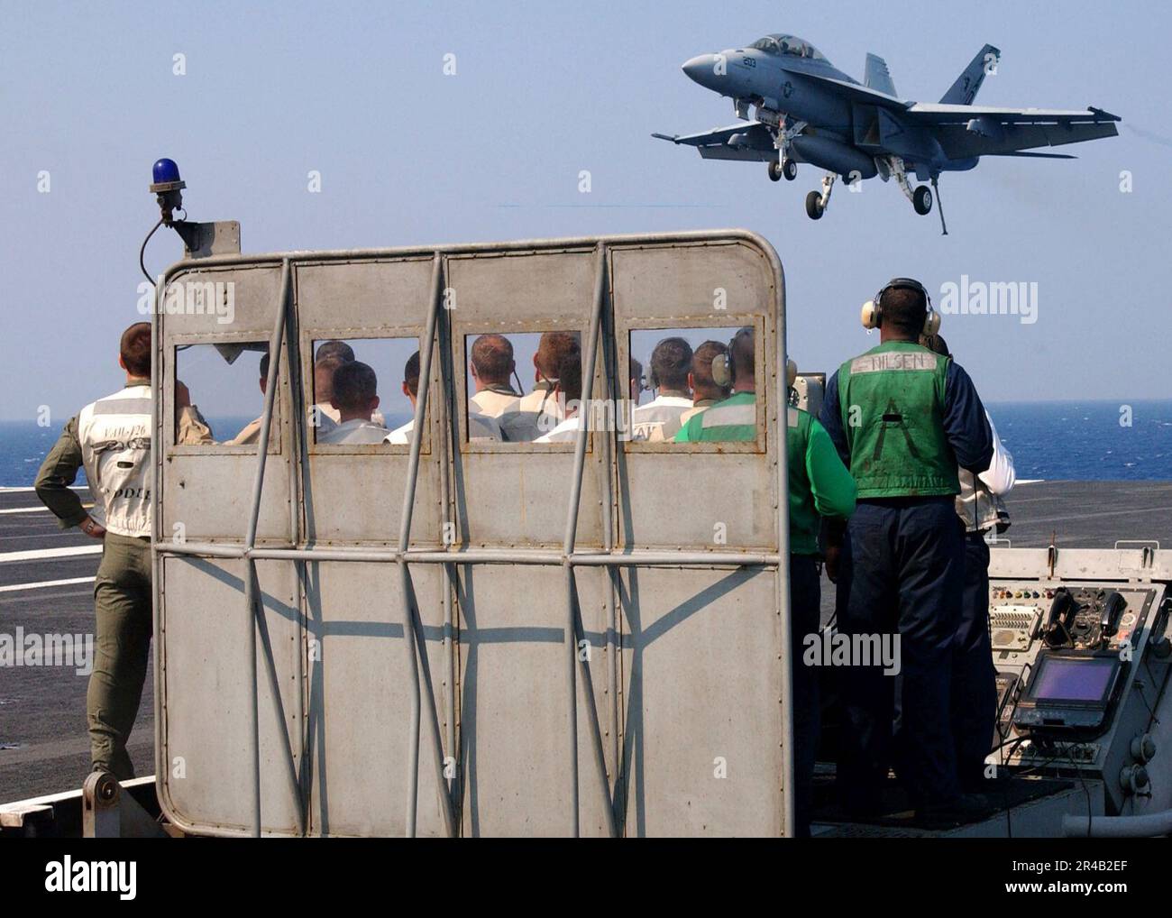 US Navy Sailors and Landing Signal Officers (LSO) watch from the LSO ...