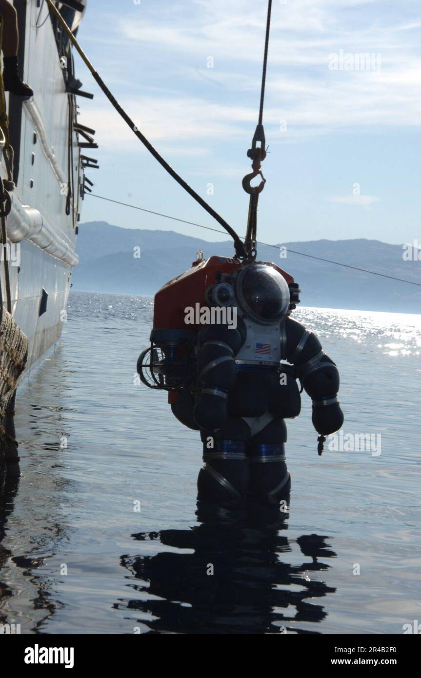US Navy U.S. Navy civilian contractor is lowered into the water in the ...