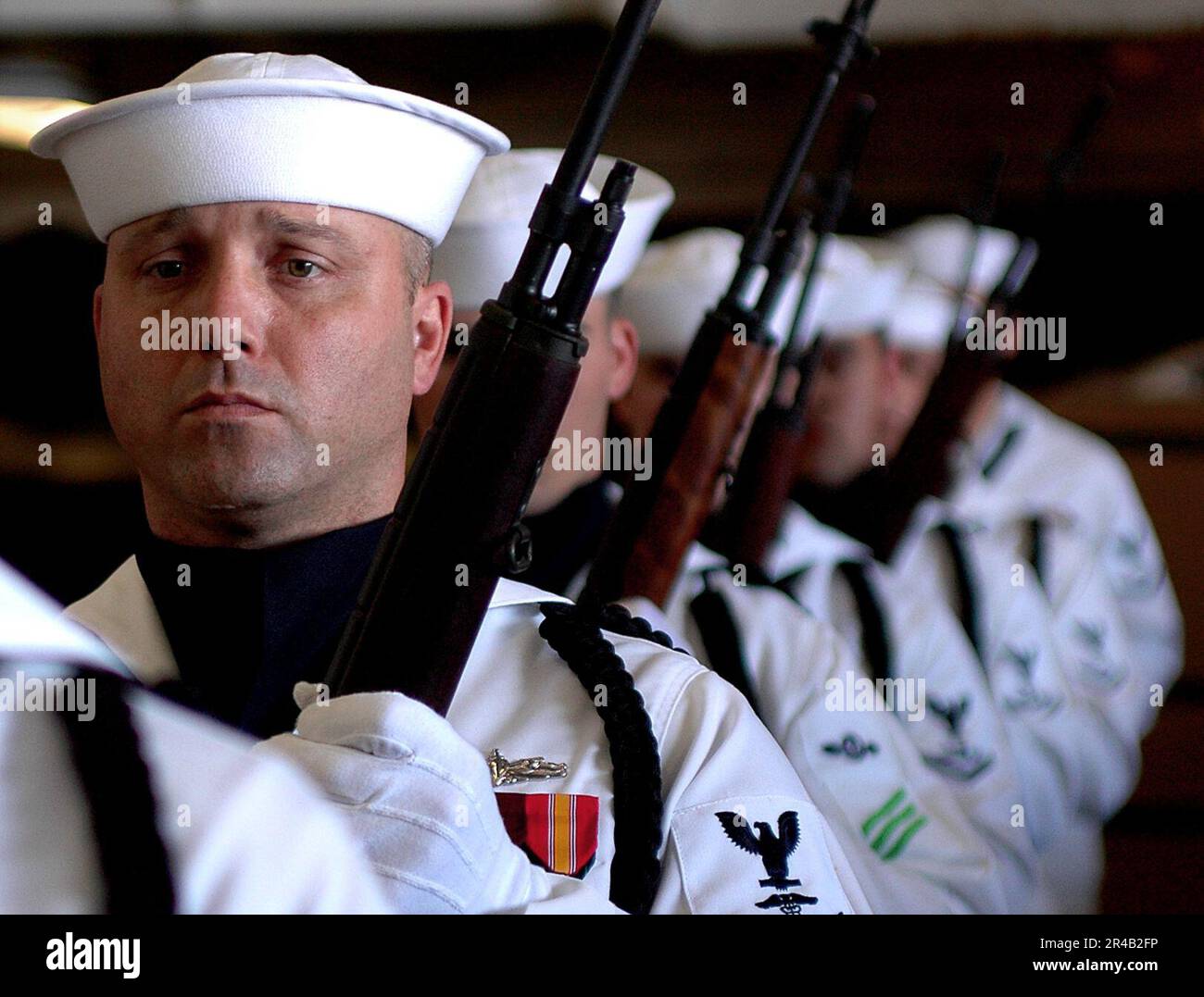 US Navy Members of the ceremonial honor guard stand at port arms during ...